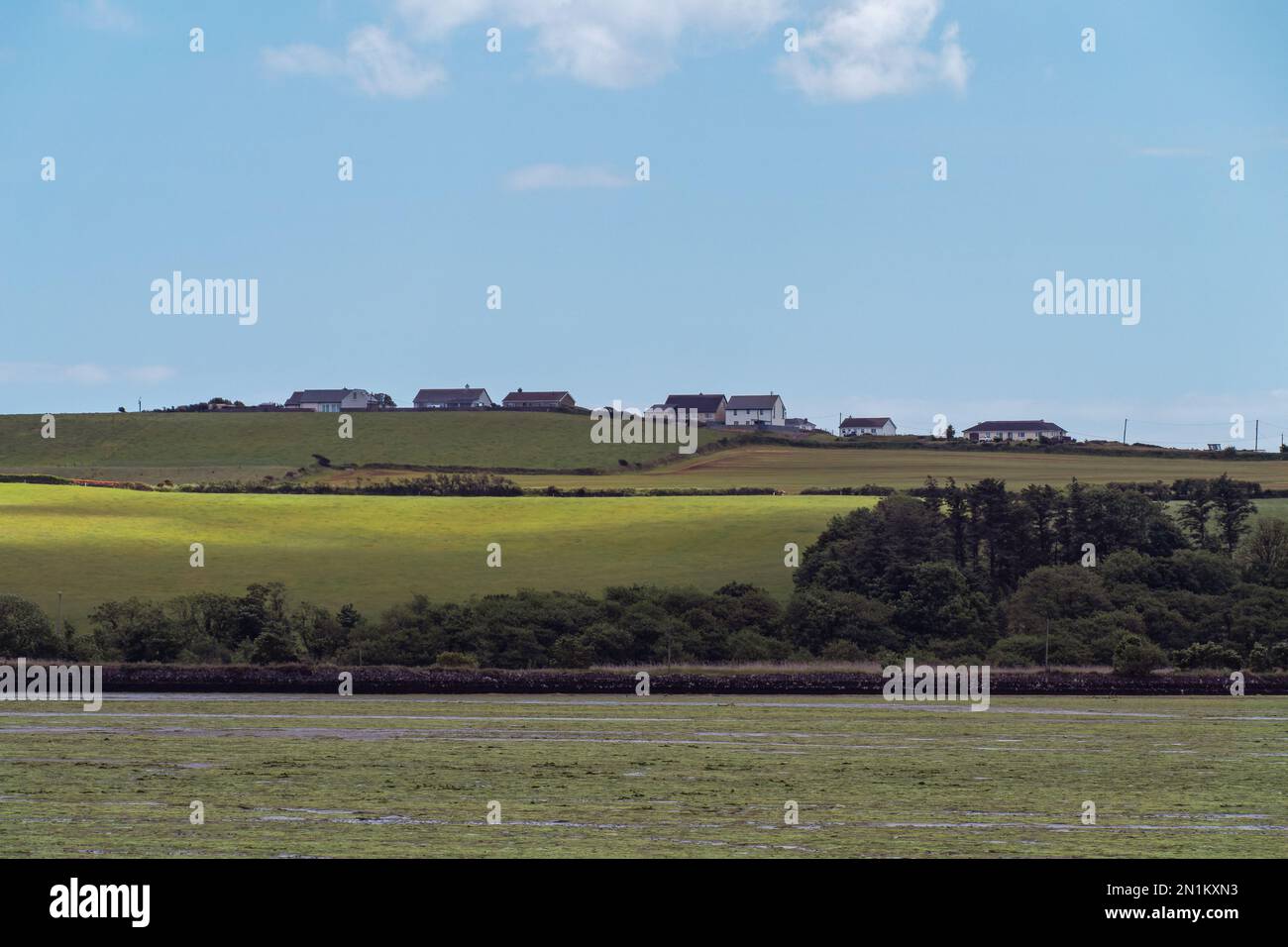 A houses on a hill, blue sky on a summer day. A small Irish village ...