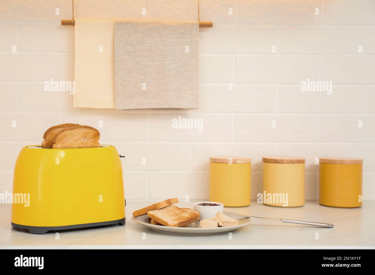 Modern toaster and tasty breakfast on counter in kitchen Stock Photo ...