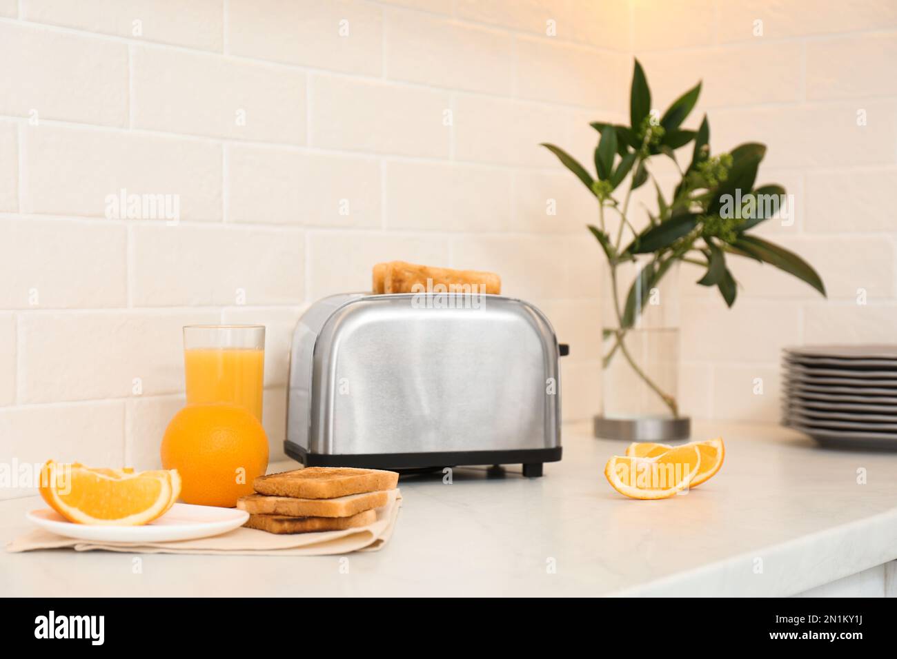 Modern toaster and tasty breakfast on counter in kitchen Stock Photo ...