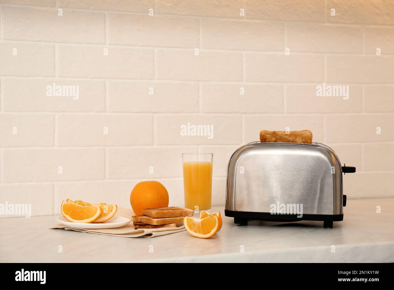 Modern toaster and tasty breakfast on counter in kitchen Stock Photo ...