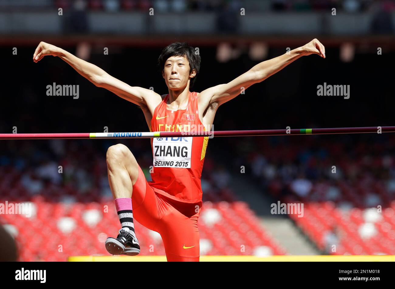 China's Zhang Guowei reacts as he clears the bar in the men's high jump ...