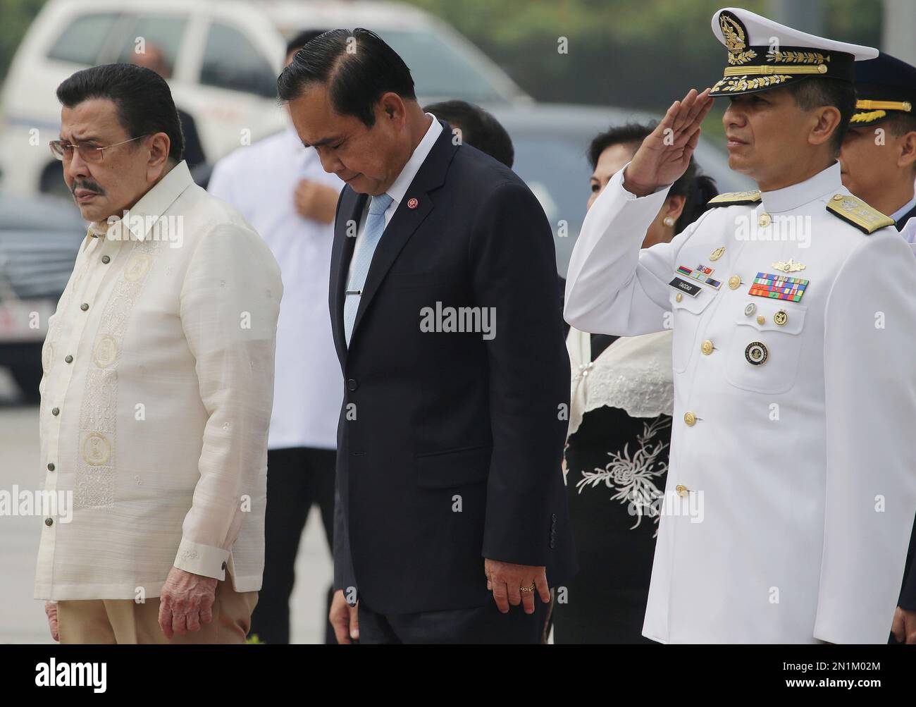 Thai Prime Minister Gen. Prayuth Chan-ocha, center, bows beside former ...