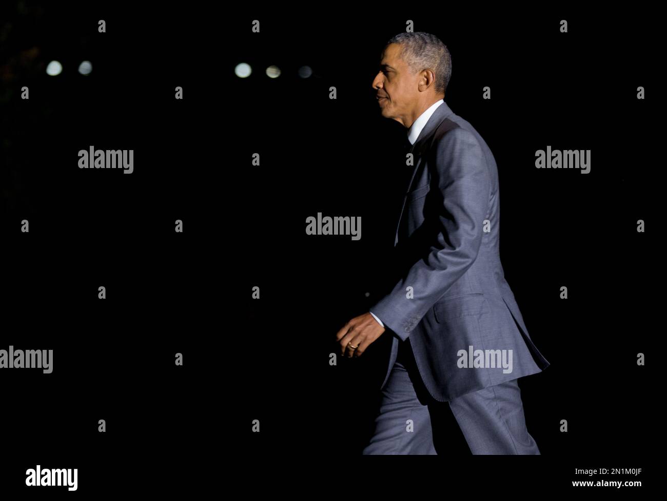 President Barack Obama walks on the South Lawn of the White House in ...