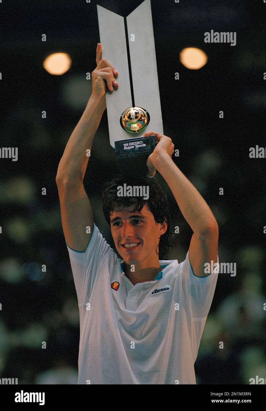 A smiling Aaron Krickstein of the United States, holds a trophy aloft ...