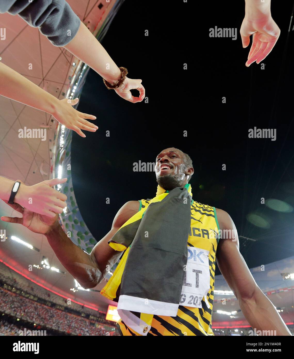 Jamaica's Usain Bolt greets the crowd as he celebrates after winning ...