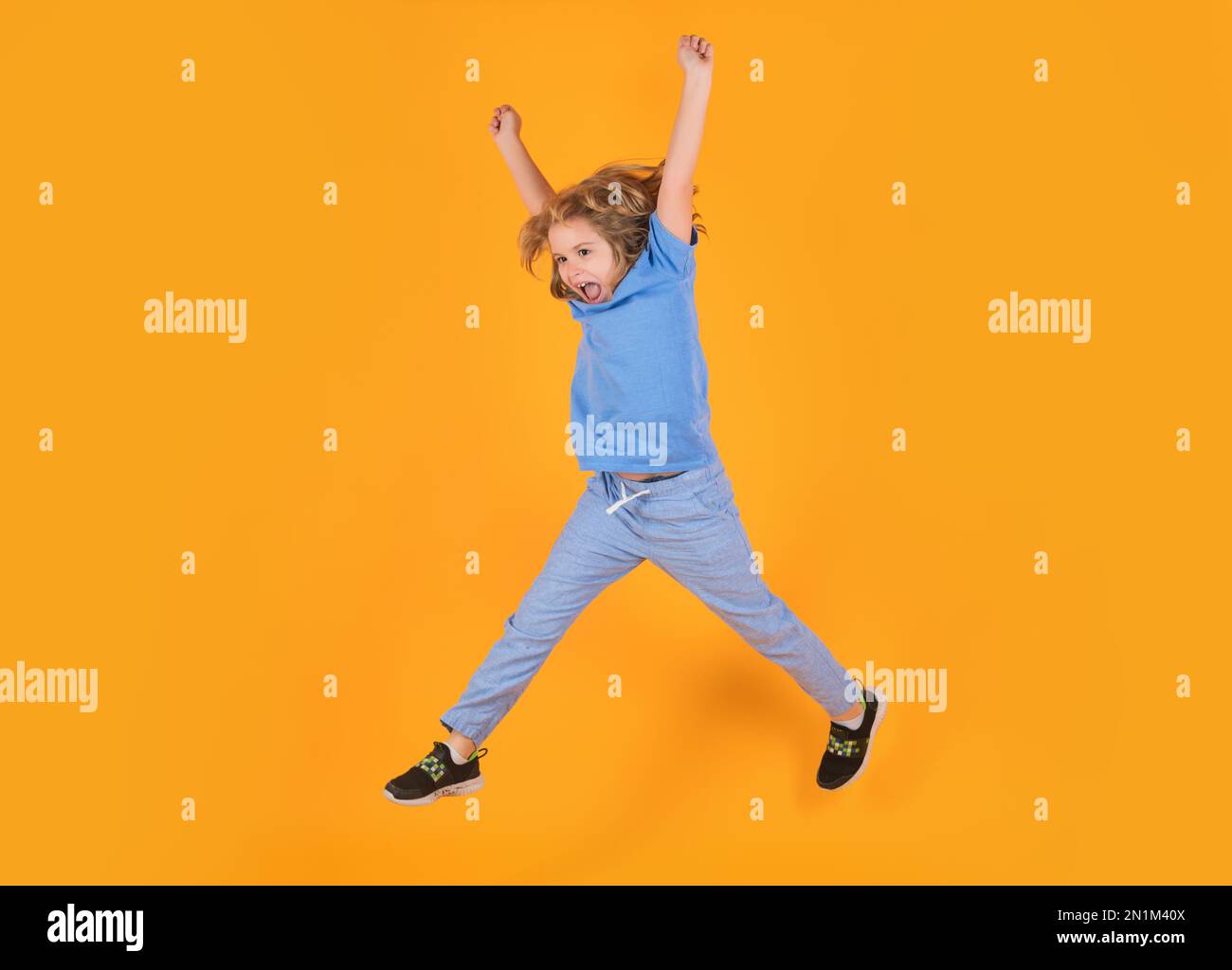 Full length of excited kid jumping. Full length photo of kid boy jump ...
