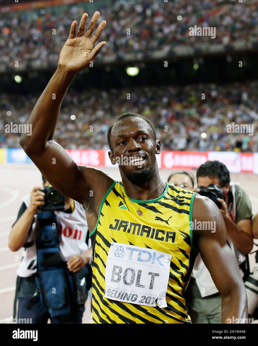 Jamaica's Usain Bolt waves to the crowd as he celebrates after winning ...
