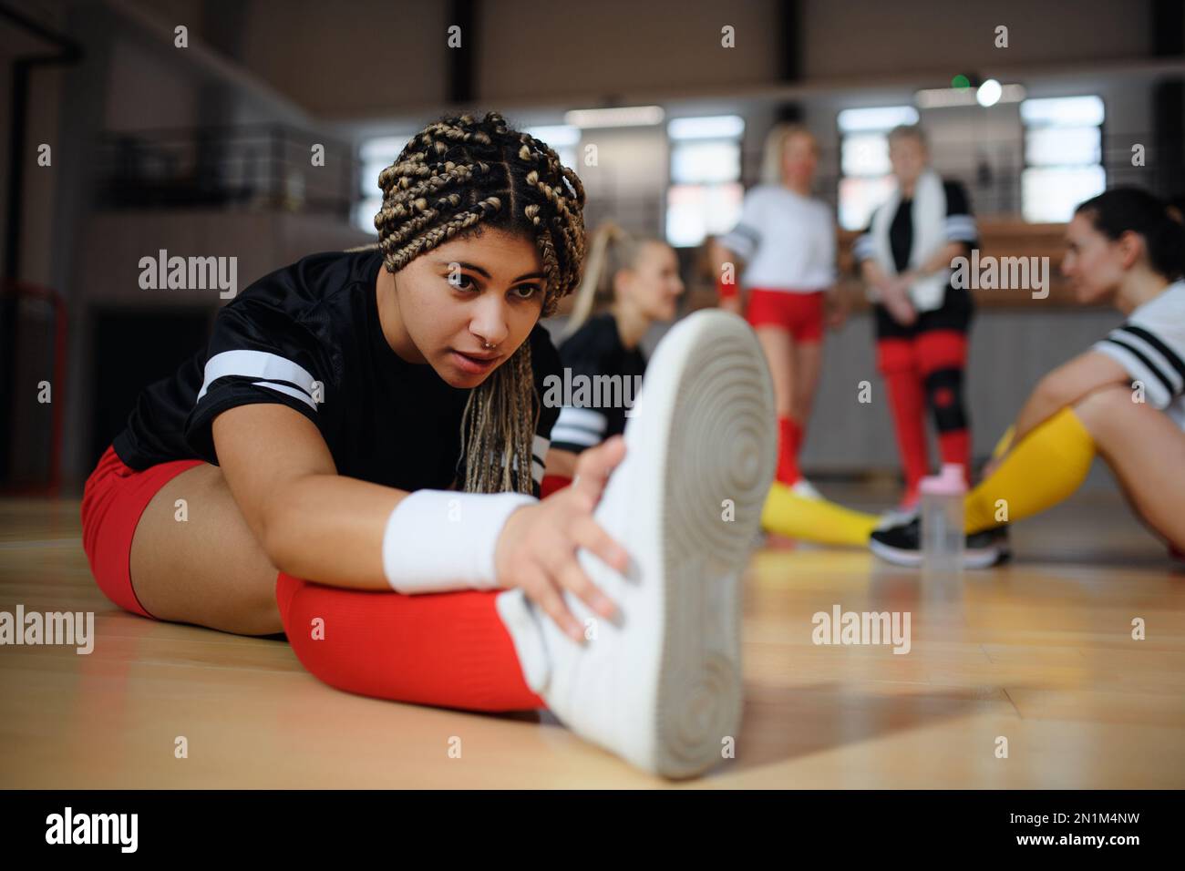 Group of multiaged women, sports team players. in gym stretching ...