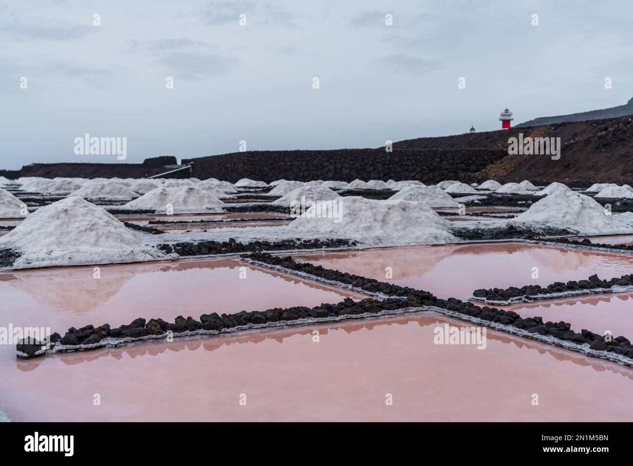 Bright purple salt mine pools with piles of salt Stock Photo - Alamy