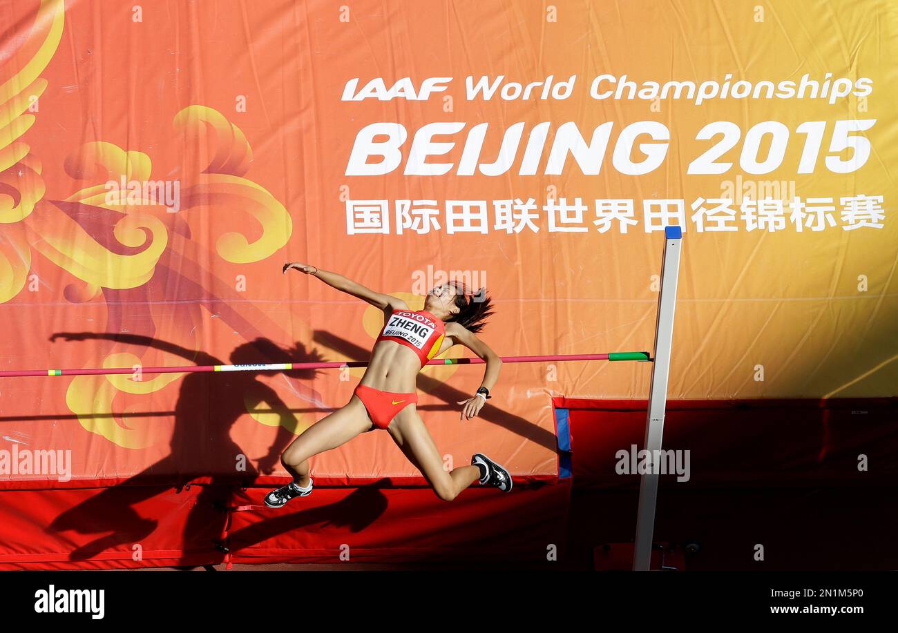 China's Zheng Xingjuan competes in the women's high jump qualification ...