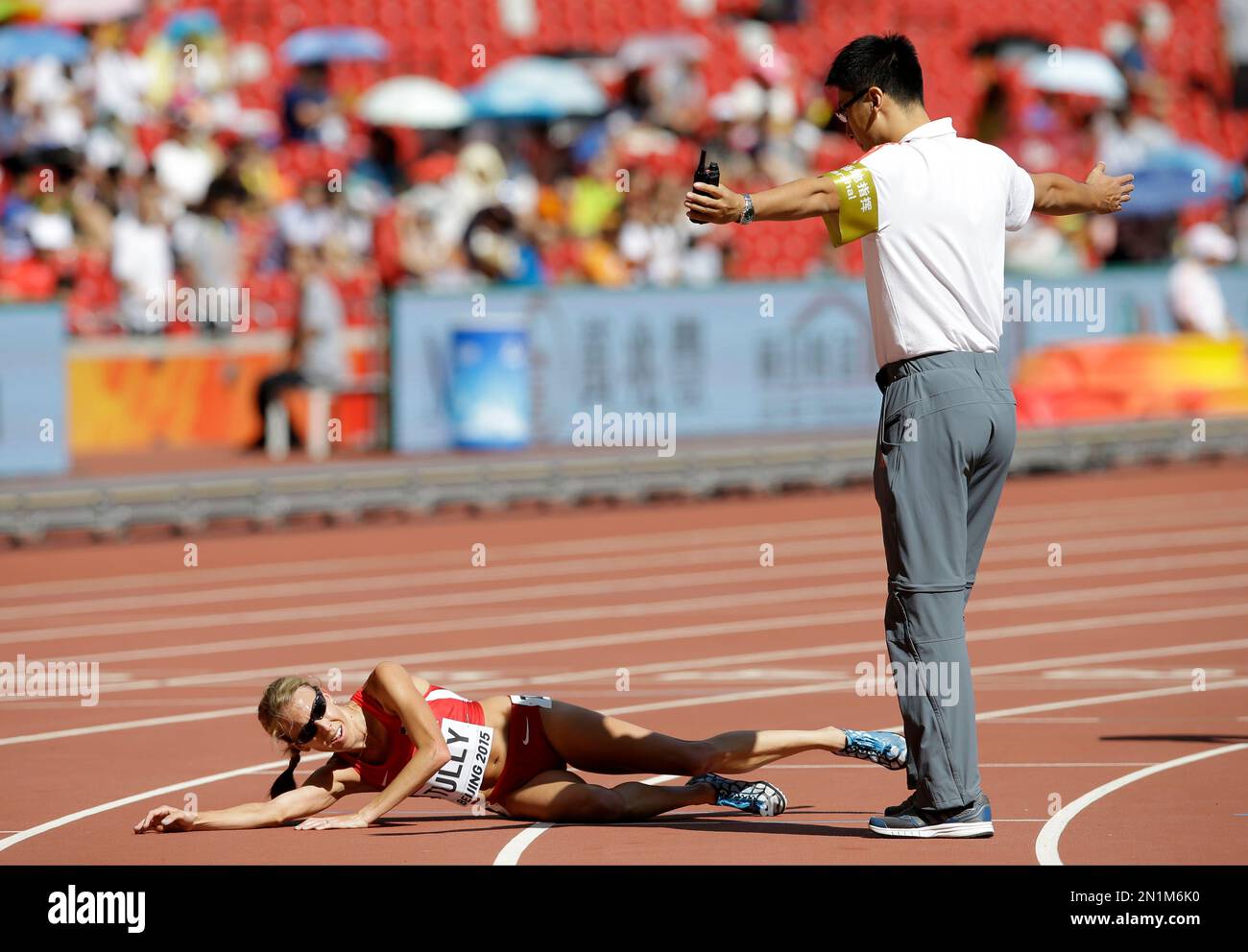 United States' Nicole Tully collapses on the track after finishing a ...