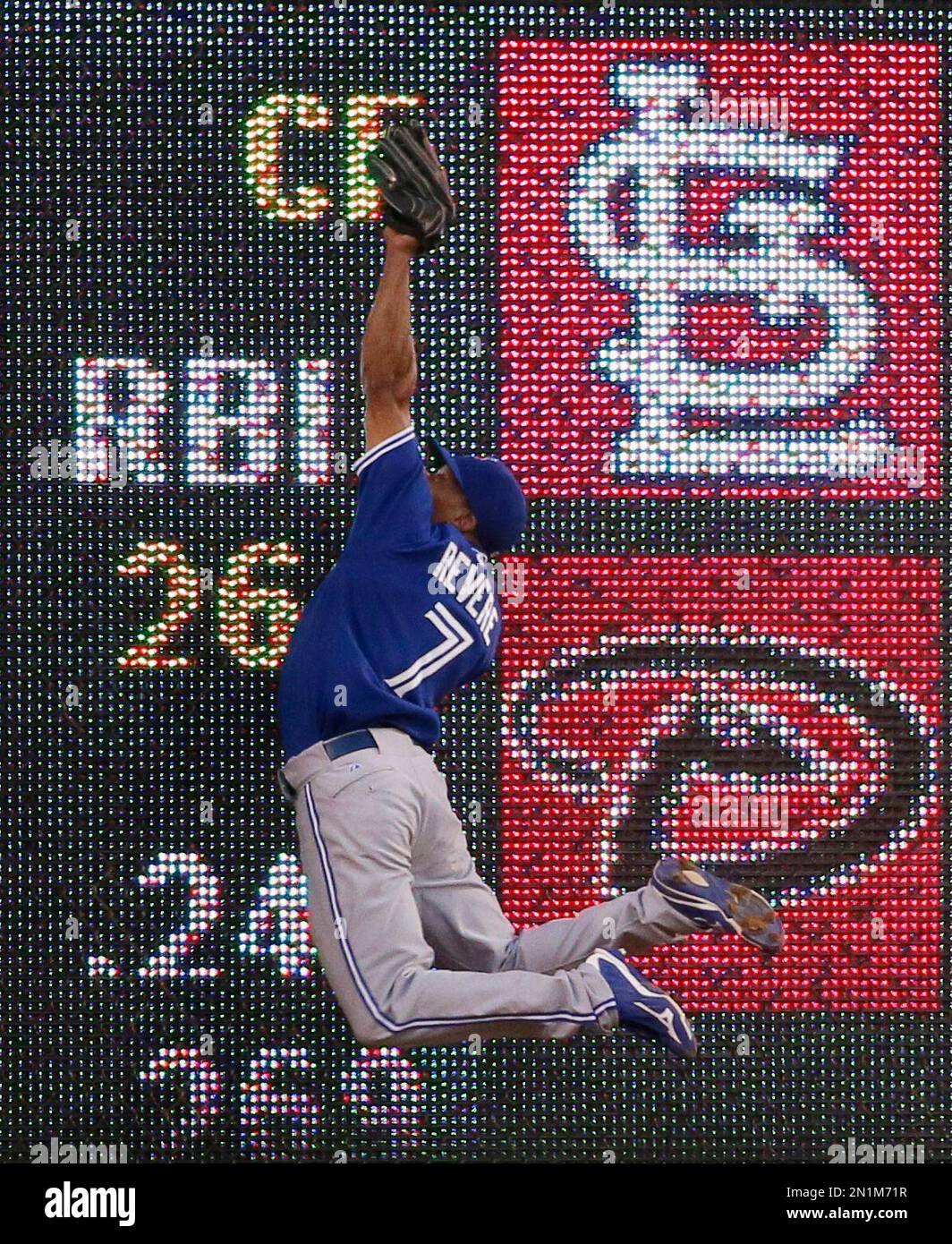 Toronto Blue Jays left fielder Ben Revere leaps up grabbing a fly out ...