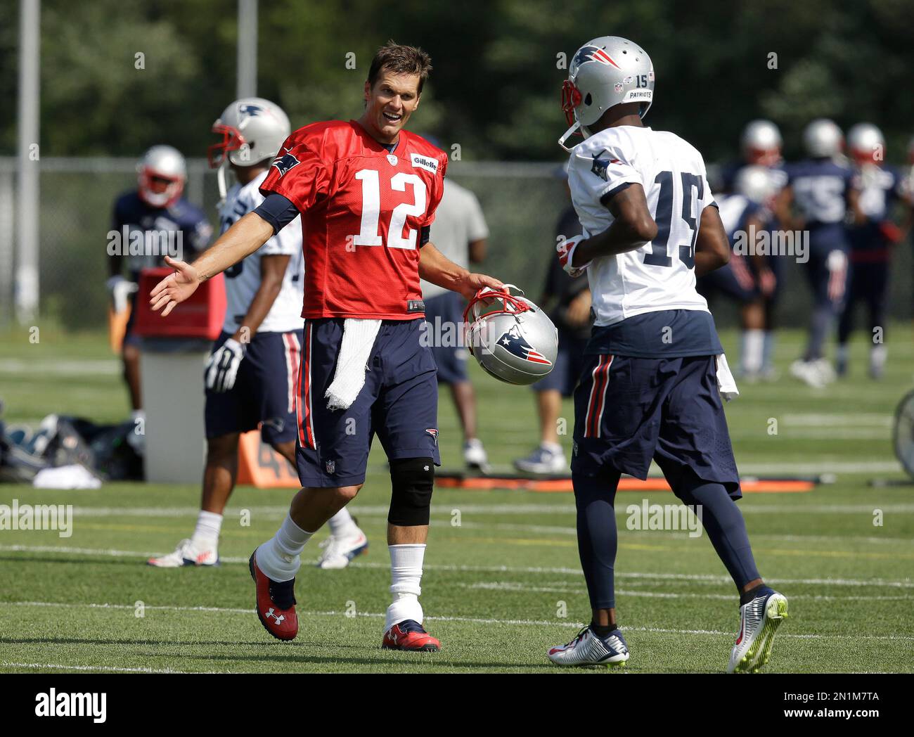 New England Patriots quarterback Tom Brady, left, walks toward Patriots ...