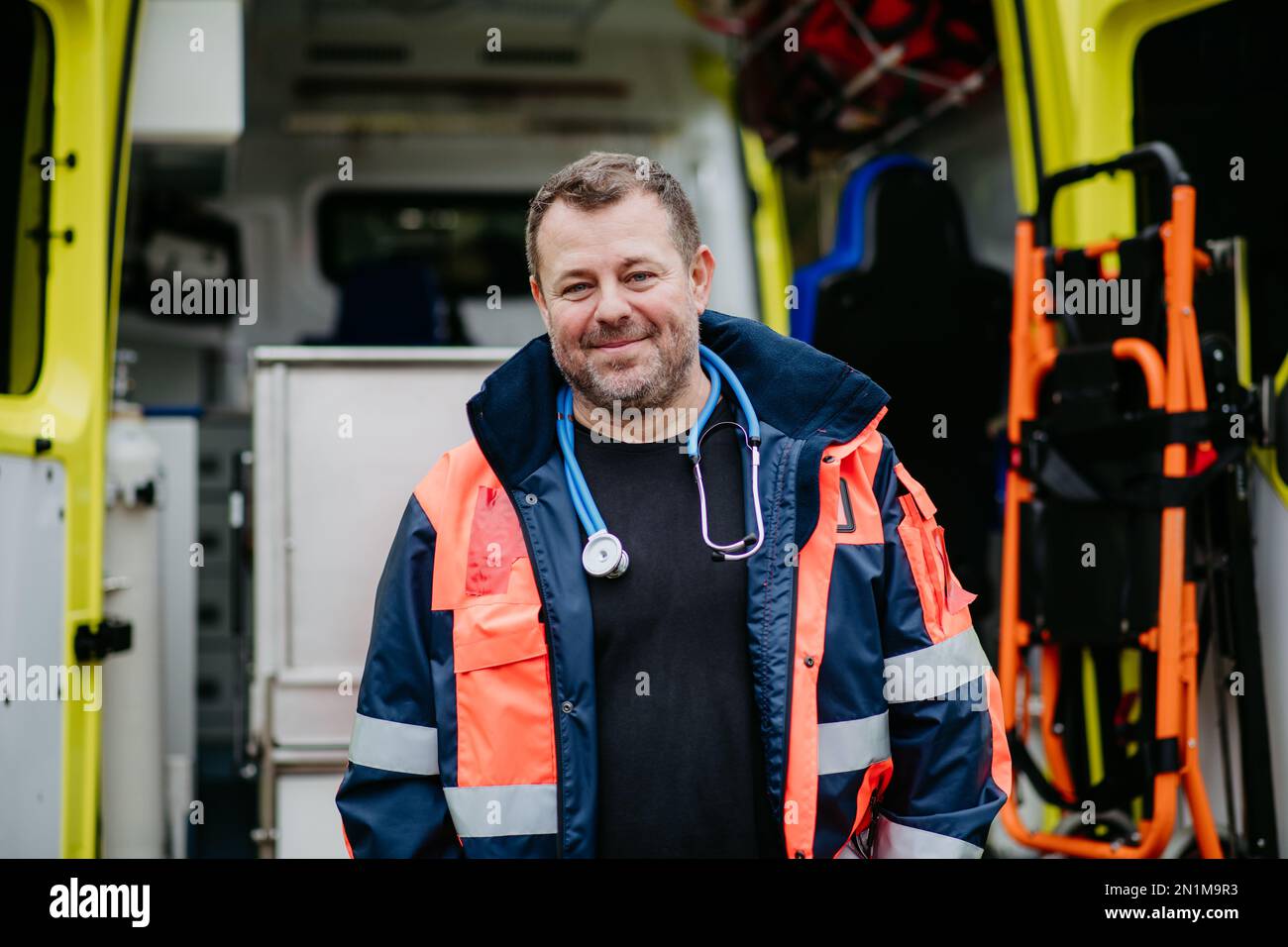 Portrait of doctor standing in front of ambulance car Stock Photo - Alamy