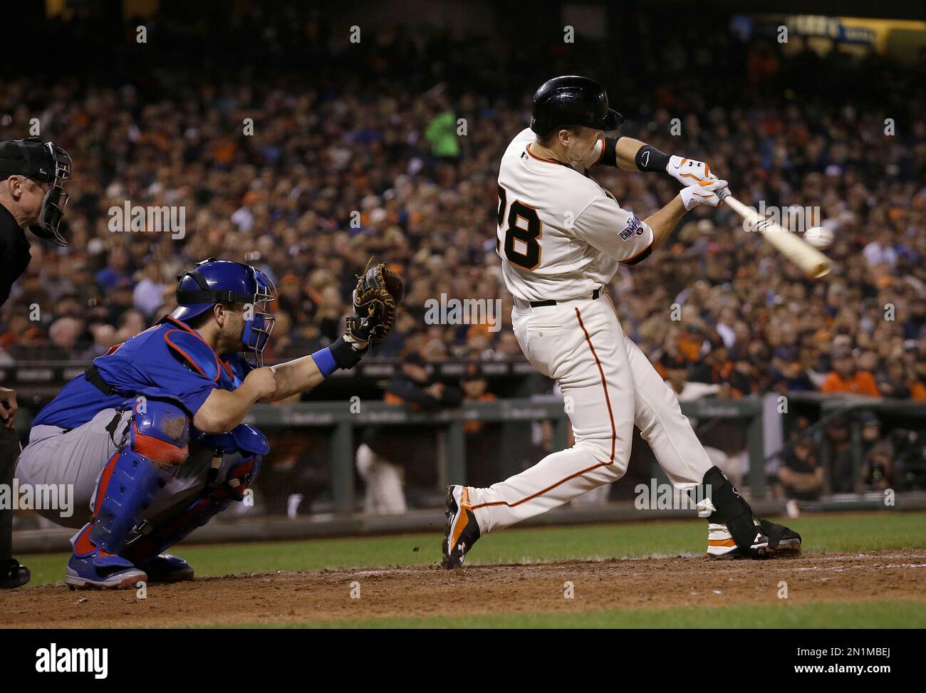 San Francisco Giants' Buster Posey, right, hits a single in front of ...