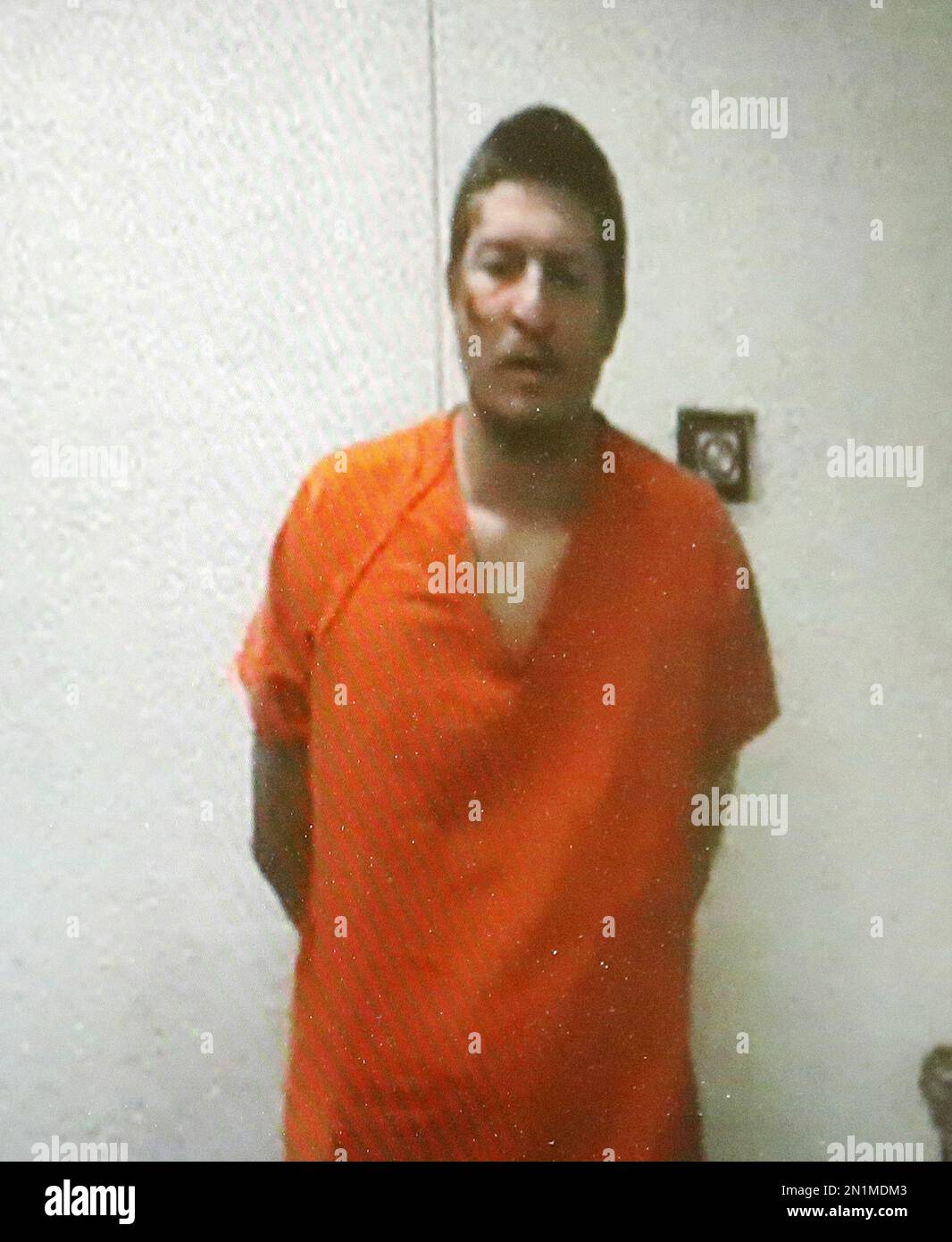 Christian Costello is pictured on a video screen as he appears before ...