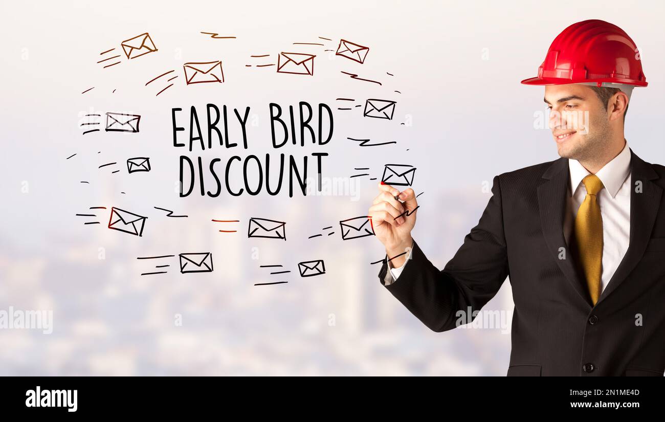 Young businessman with helmet drawing sale sign Stock Photo - Alamy