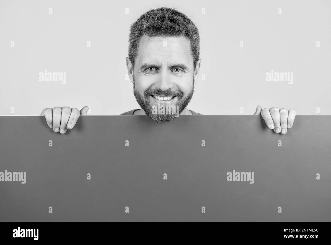 male behind paper sheet. place for useful information. copy space ...