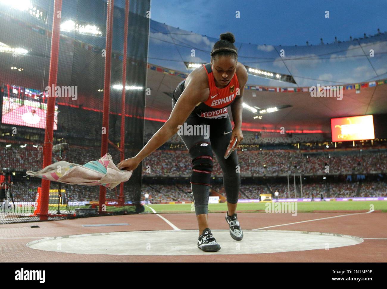 Germany's Shanice Craft cleans the throwing circle before competing in ...