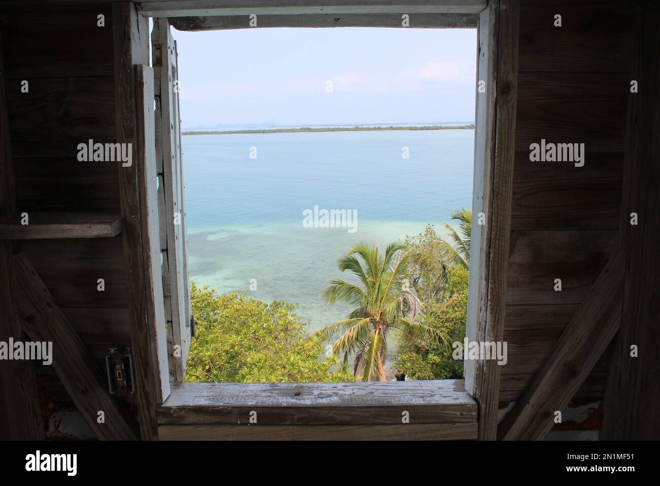 a distant tropical island seen through a wooden window frame Stock ...