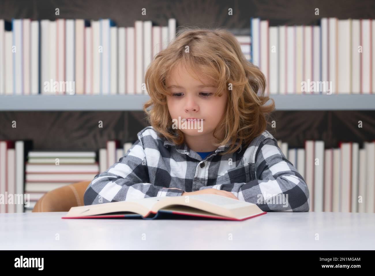 Education and school concept. Portrait of school boy reading book in ...