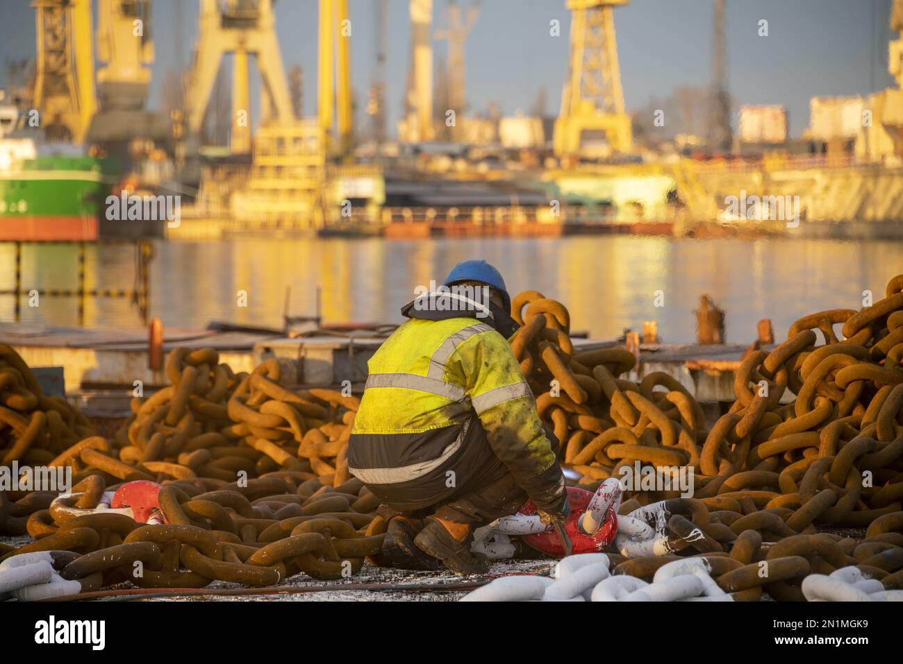 Shipbuilding worker welding chain Stock Photo - Alamy
