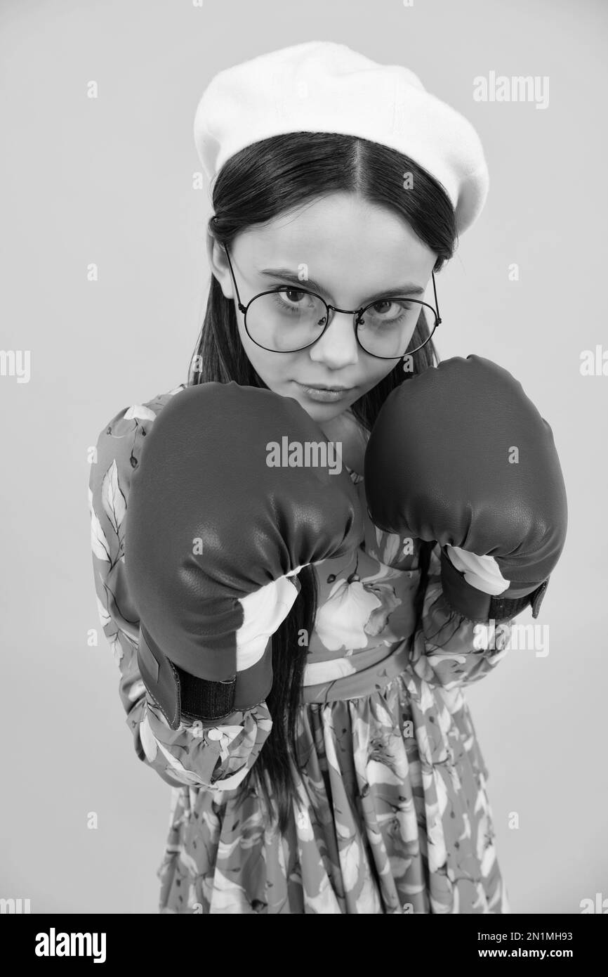 Young child girl using boxing gloves with funny face. Portrait of funny ...