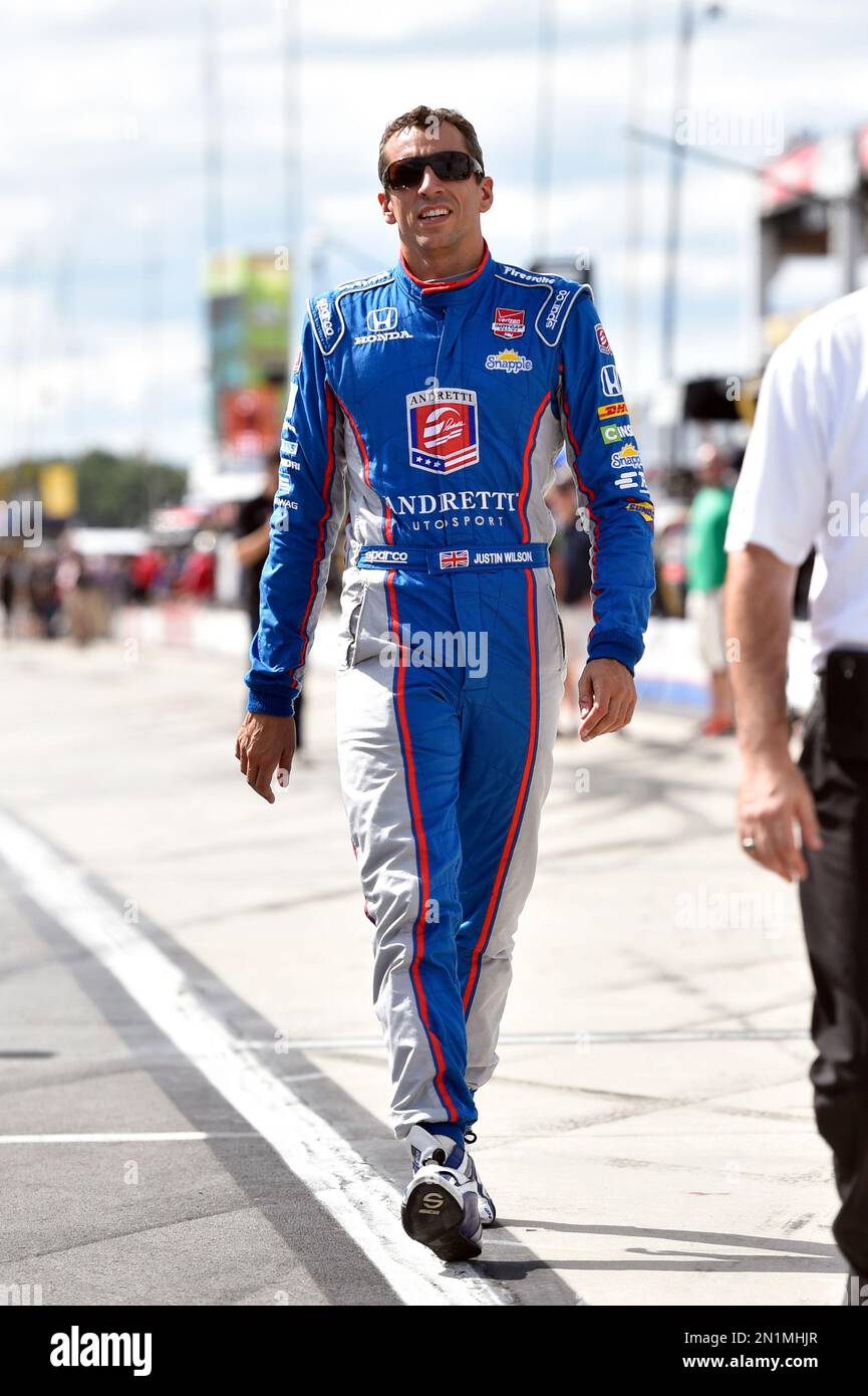 Justin Wilson, of England, walks down pit road during qualifying for ...