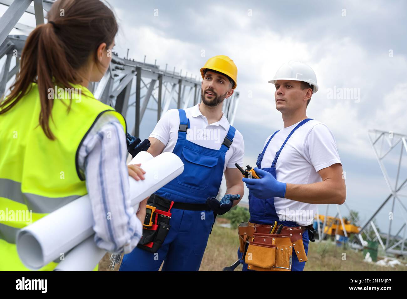 Professional engineers working on installation of electrical substation ...