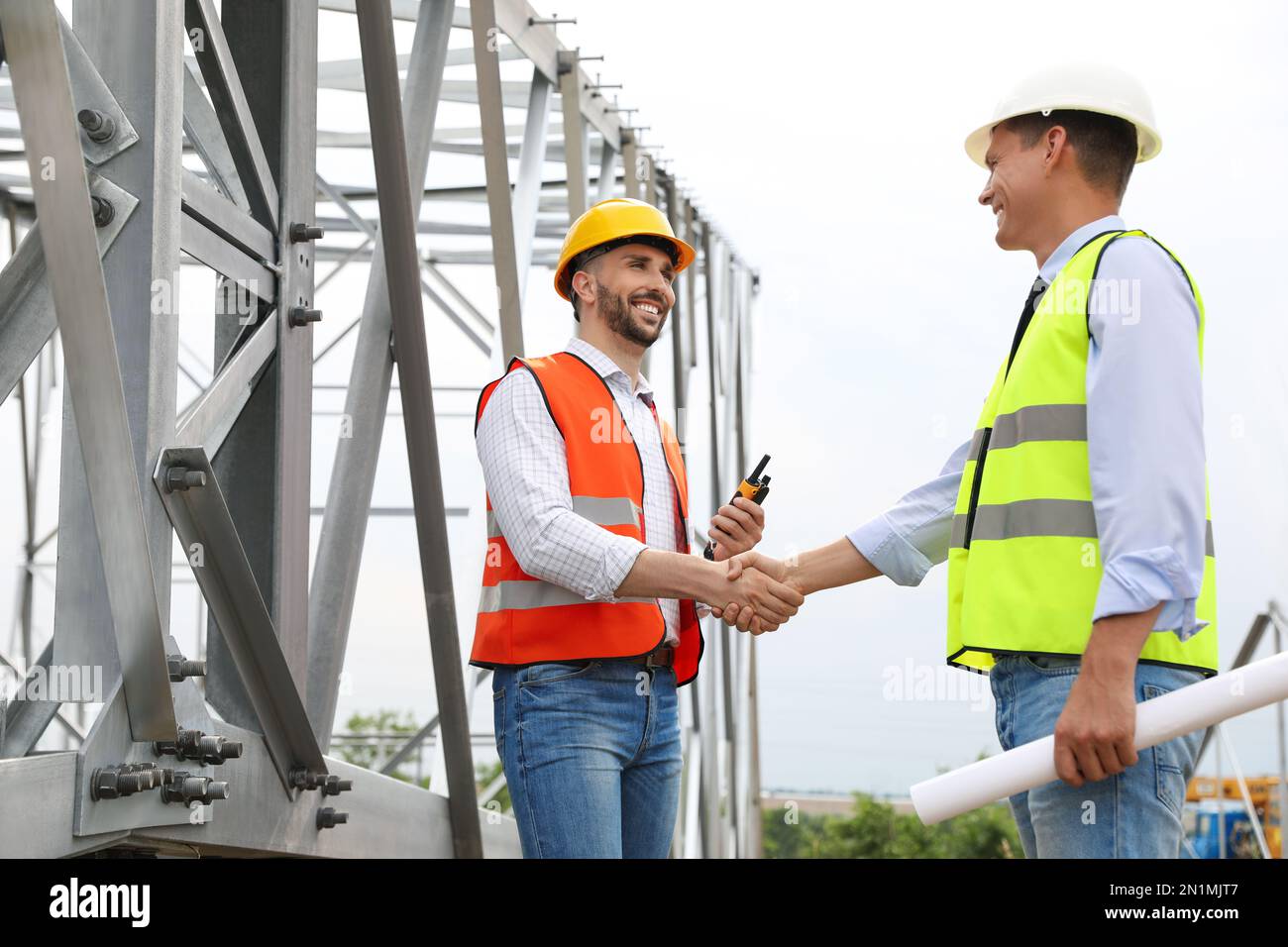 Professional engineers working on installation of electrical substation ...
