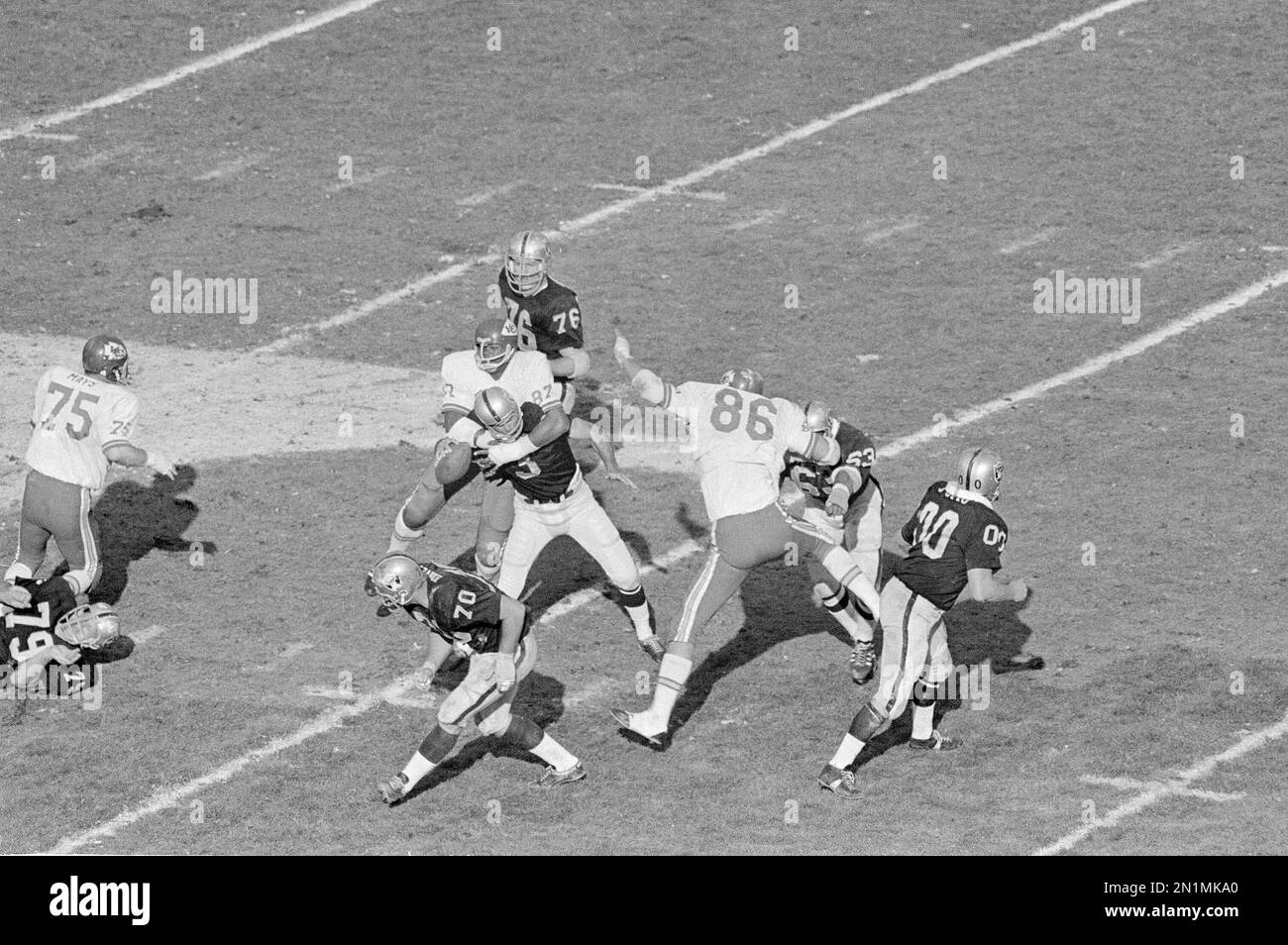 Defensive end Aaron Brown (87) of the Kansas City Chiefs wraps his arms ...