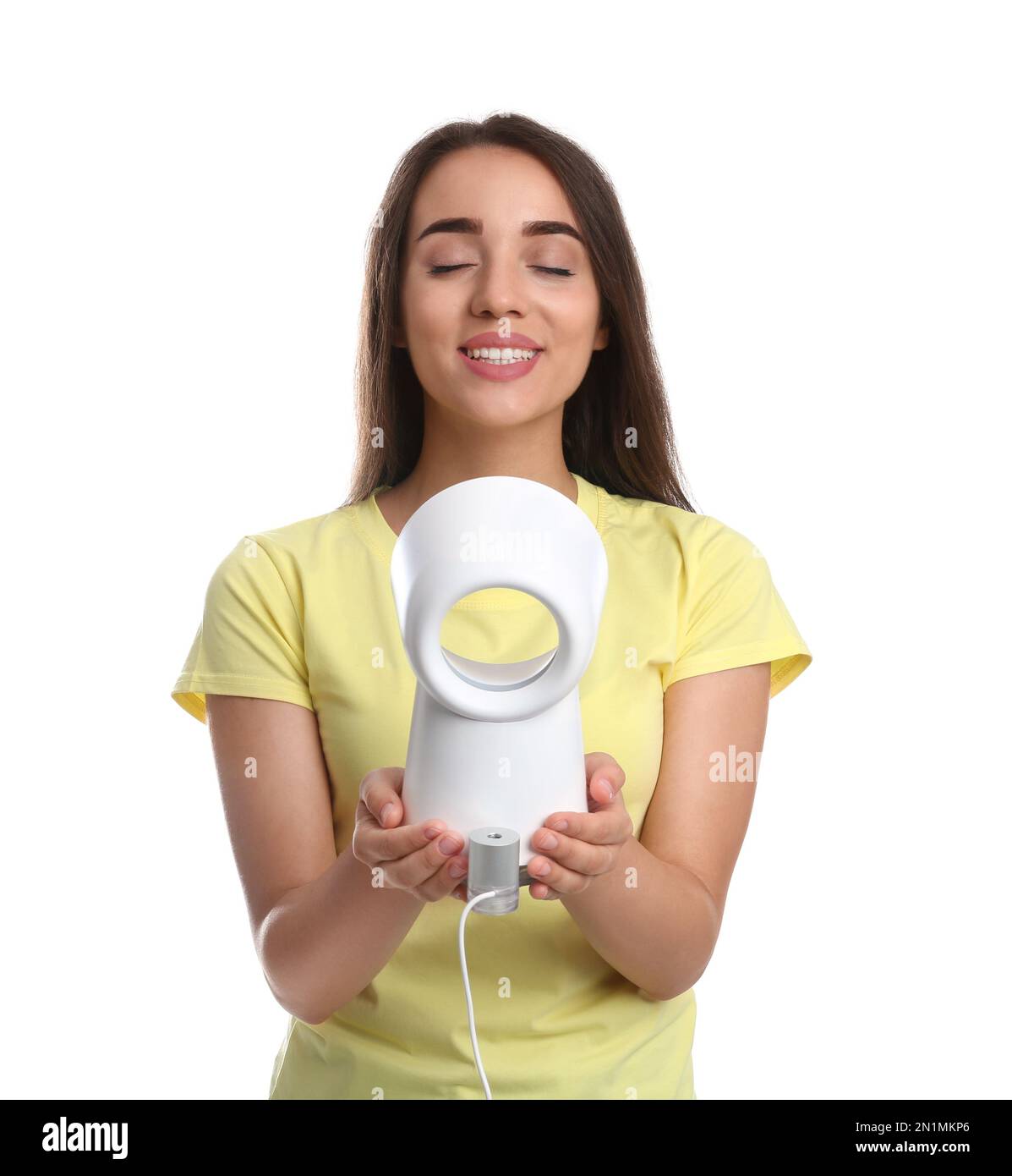 Woman enjoying air flow from portable fan on white background. Summer ...