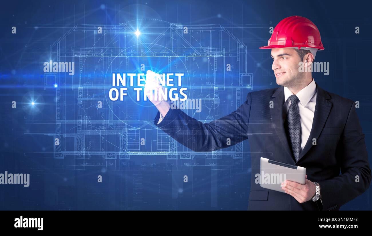 Handsome architect drawing with helmet Stock Photo - Alamy