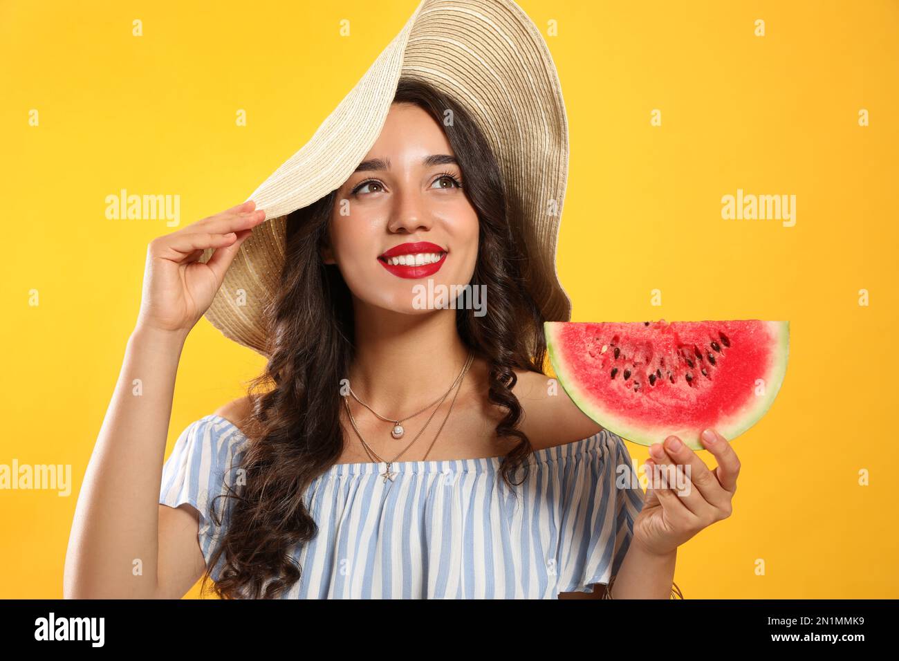 Beautiful young woman with watermelon on yellow background Stock Photo ...