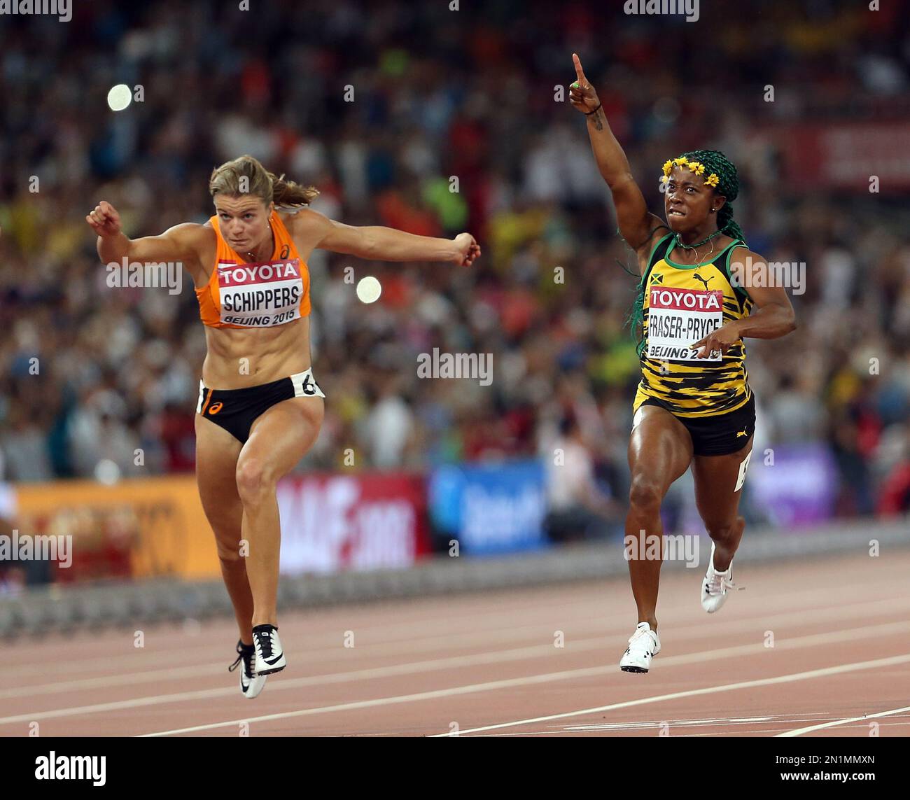 Jamaica's Shelly-Ann Fraser-Pryce, right, celebrates after winning the ...