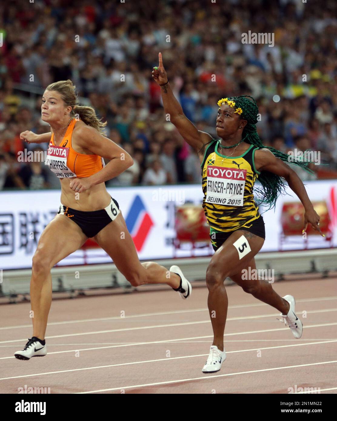 Jamaica's Shelly-Ann Fraser-Pryce, right, celebrates as she wins the ...