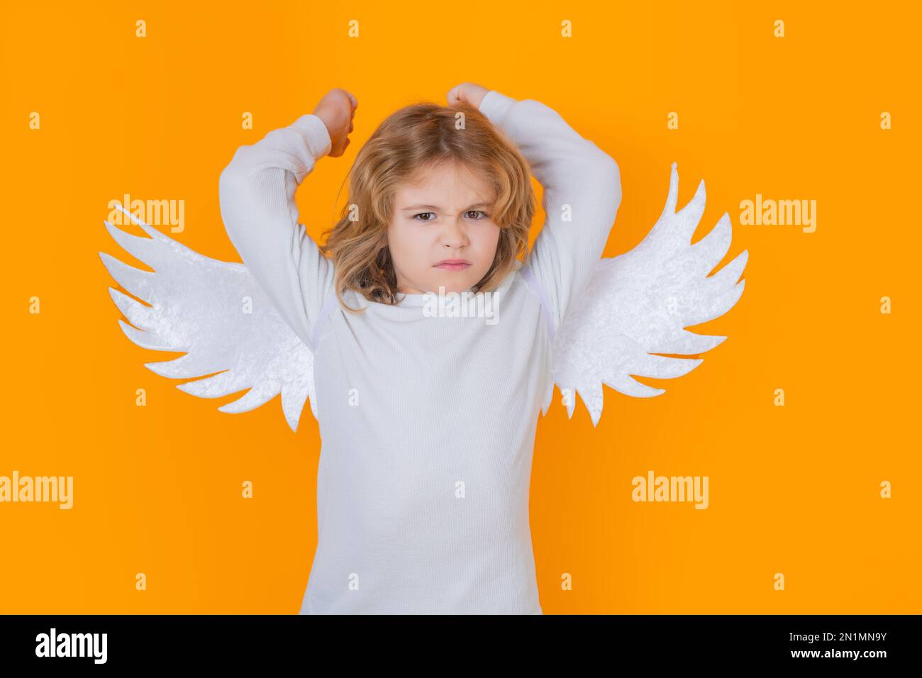 Kid wearing angel costume white dress and feather wings. Innocent child ...