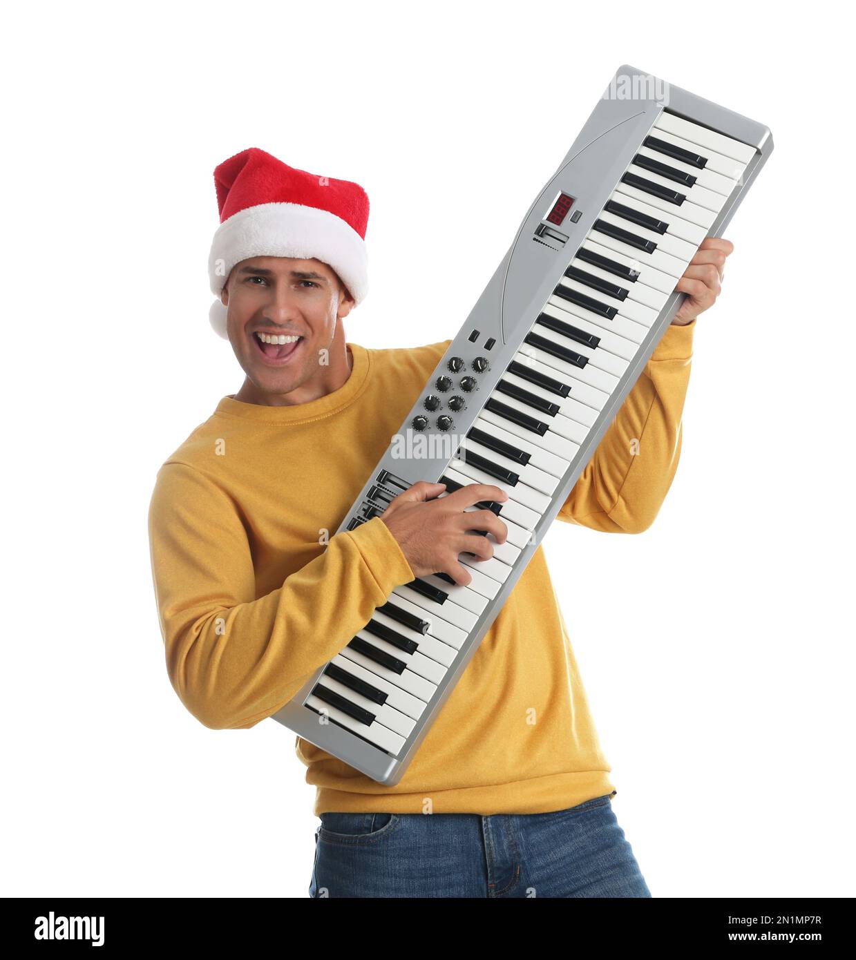 Man in Santa hat playing synthesizer on white background. Christmas ...