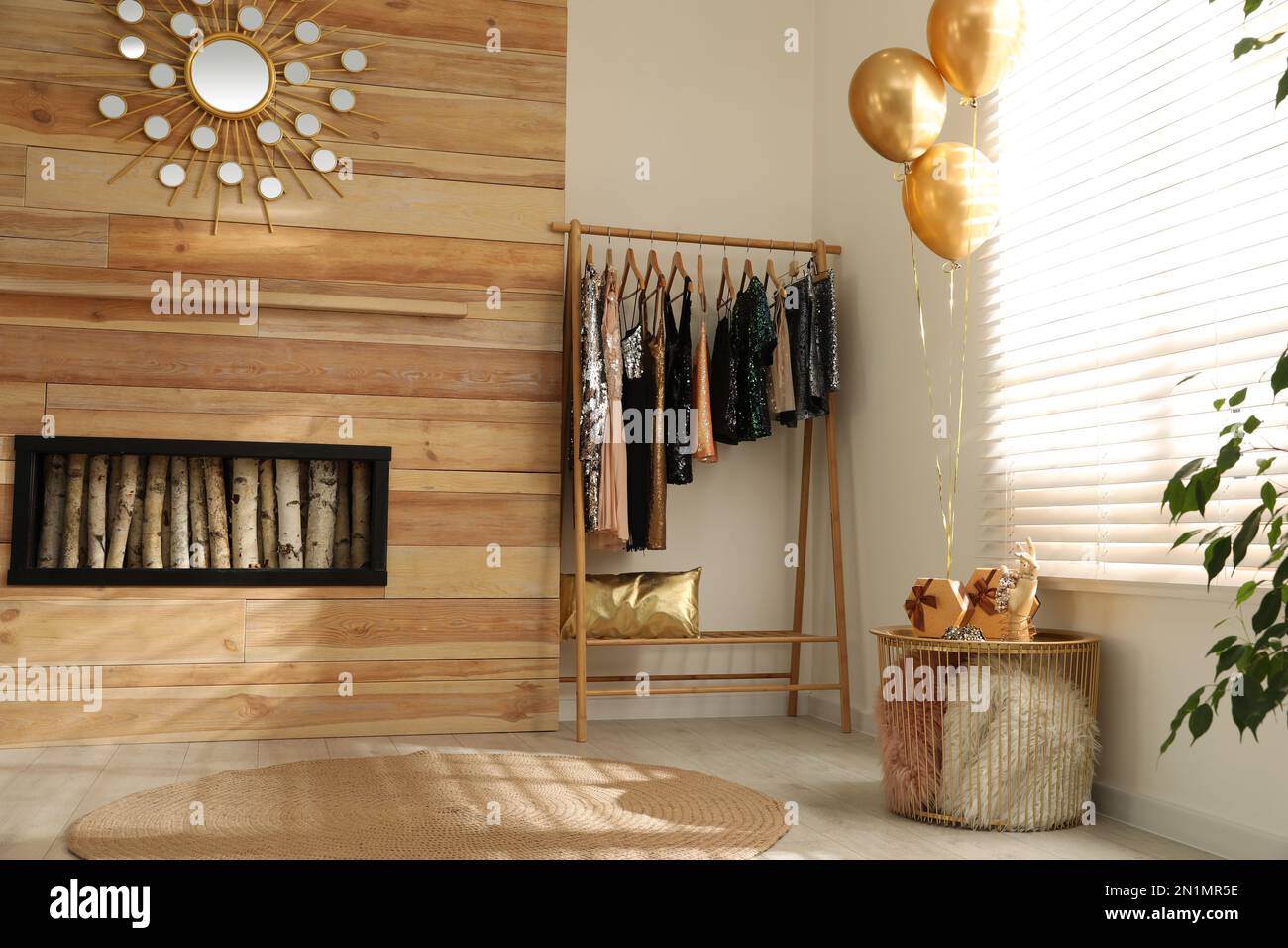 Rack with stylish women's clothes in room. Interior design Stock Photo ...