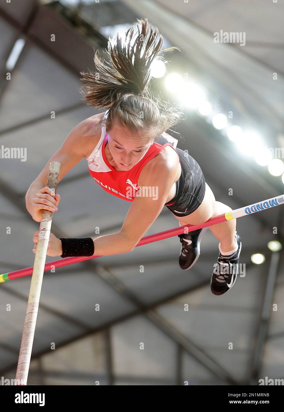Switzerland's Nicole Buechler makes a clearance in women's pole vault ...