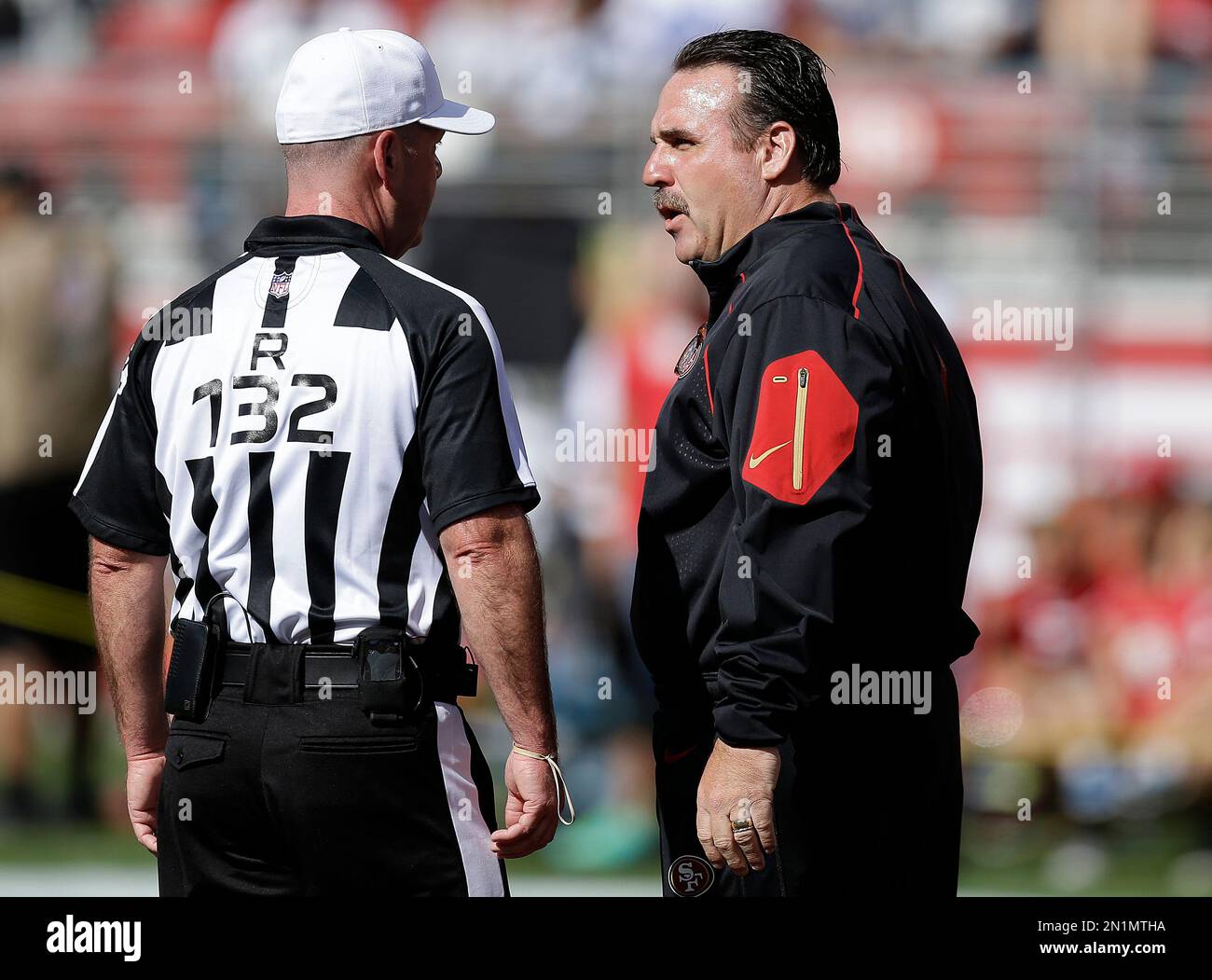 San Francisco 49ers head coach Jim Tomsula, right, talks with referee ...
