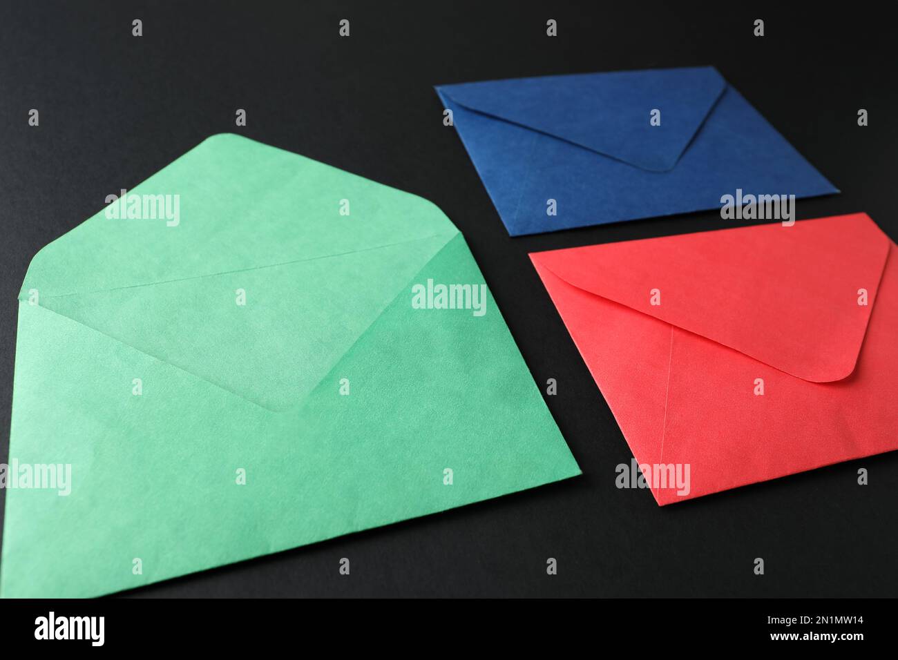 Colorful paper envelopes on black background. Mail service Stock Photo ...