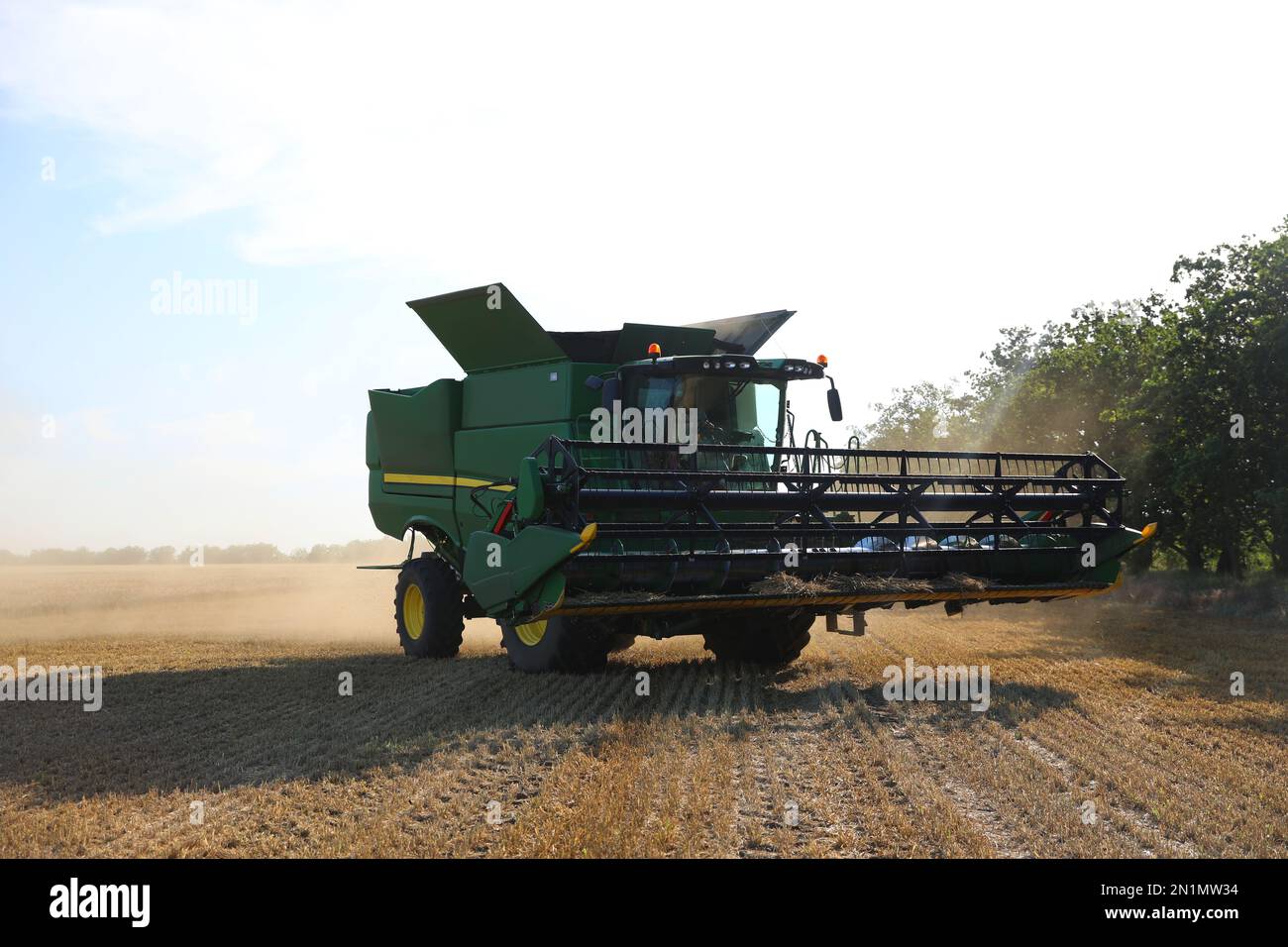 Modern combine harvester in field. Agricultural industry Stock Photo ...
