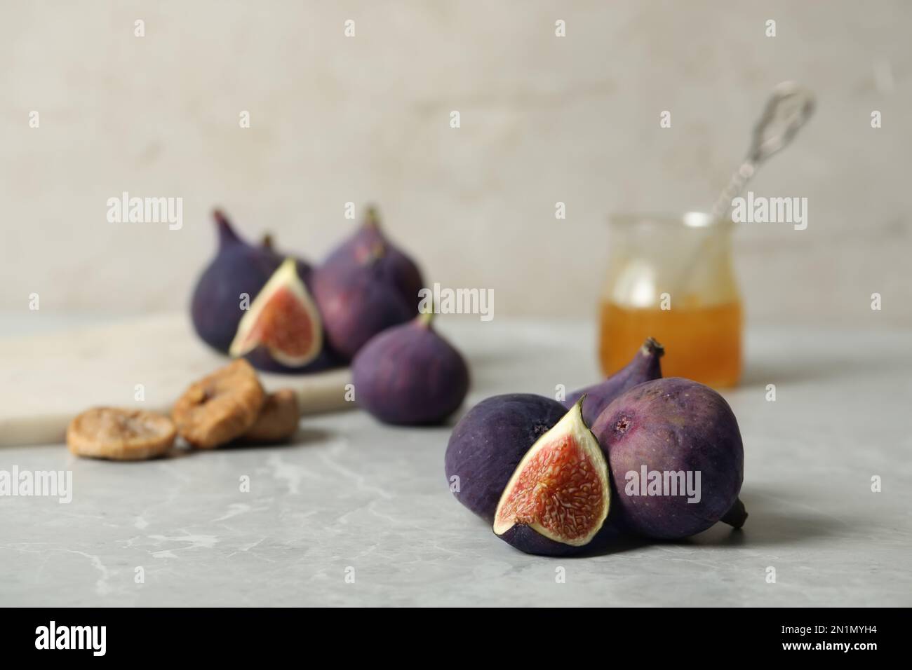 Tasty raw figs on light grey marble table. Space for text Stock Photo ...