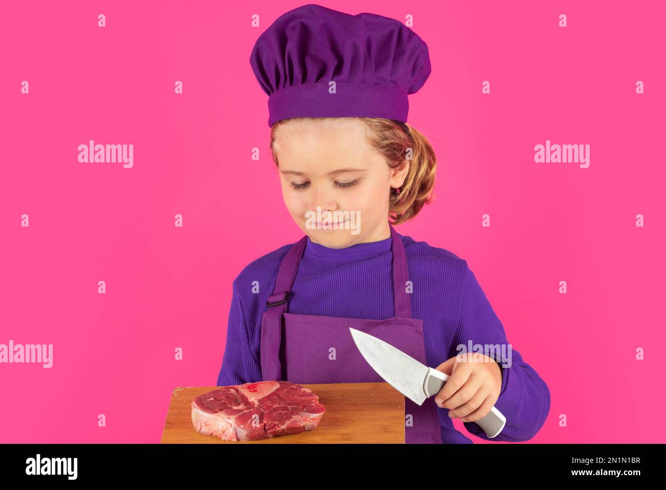 Child cook hold cutting board with meat beef steak and knife. Child ...