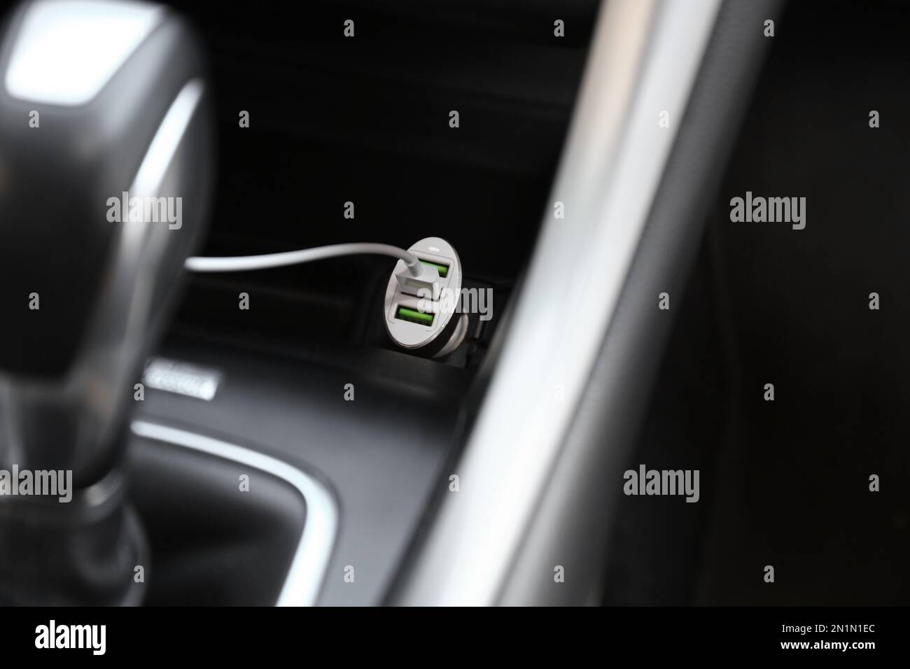 Charging cable connected to plug in car Stock Photo - Alamy