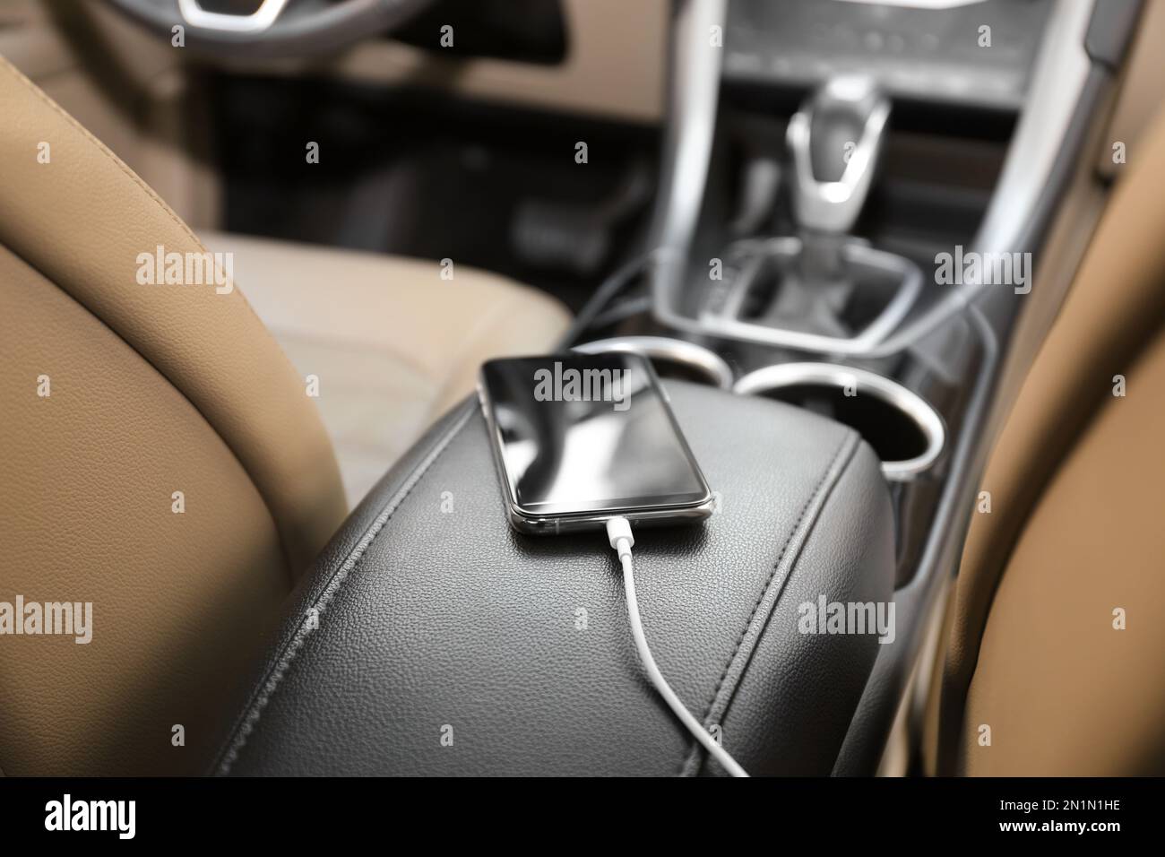 Mobile phone with charging cable in car Stock Photo - Alamy