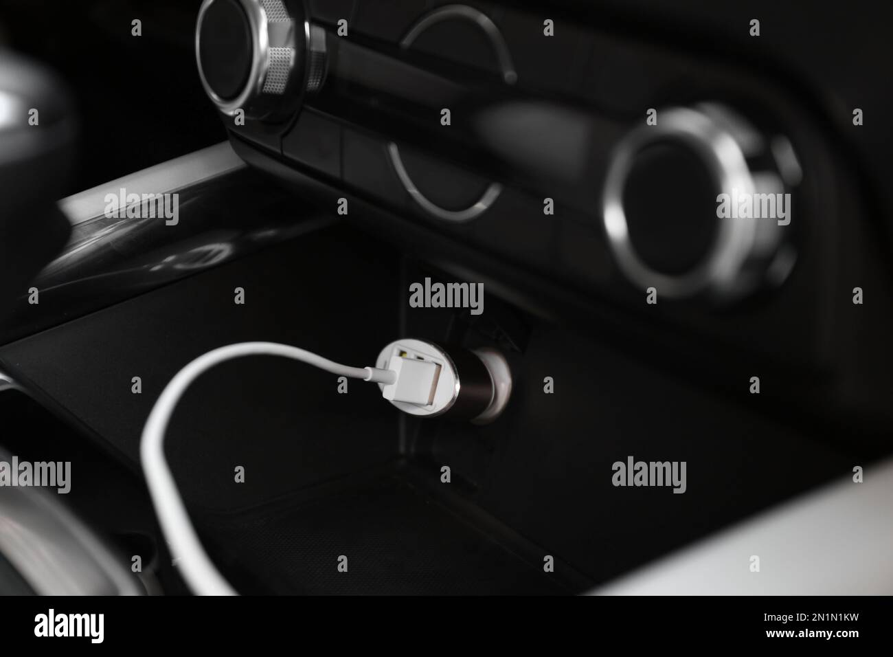 Charging cable connected to plug in car Stock Photo - Alamy