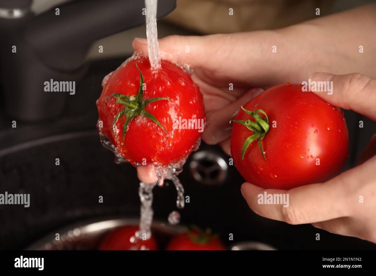 Washing tomatoes in running water hi-res stock photography and images ...