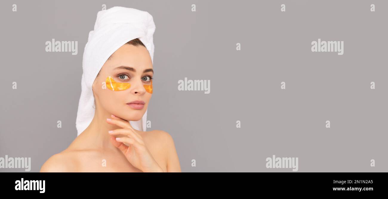 beautiful girl with terry towel use facial golden eye patch for skin ...